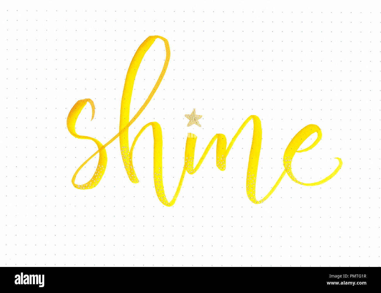 "Shine" golden hand lettering with a gold star Stock Photo - Alamy