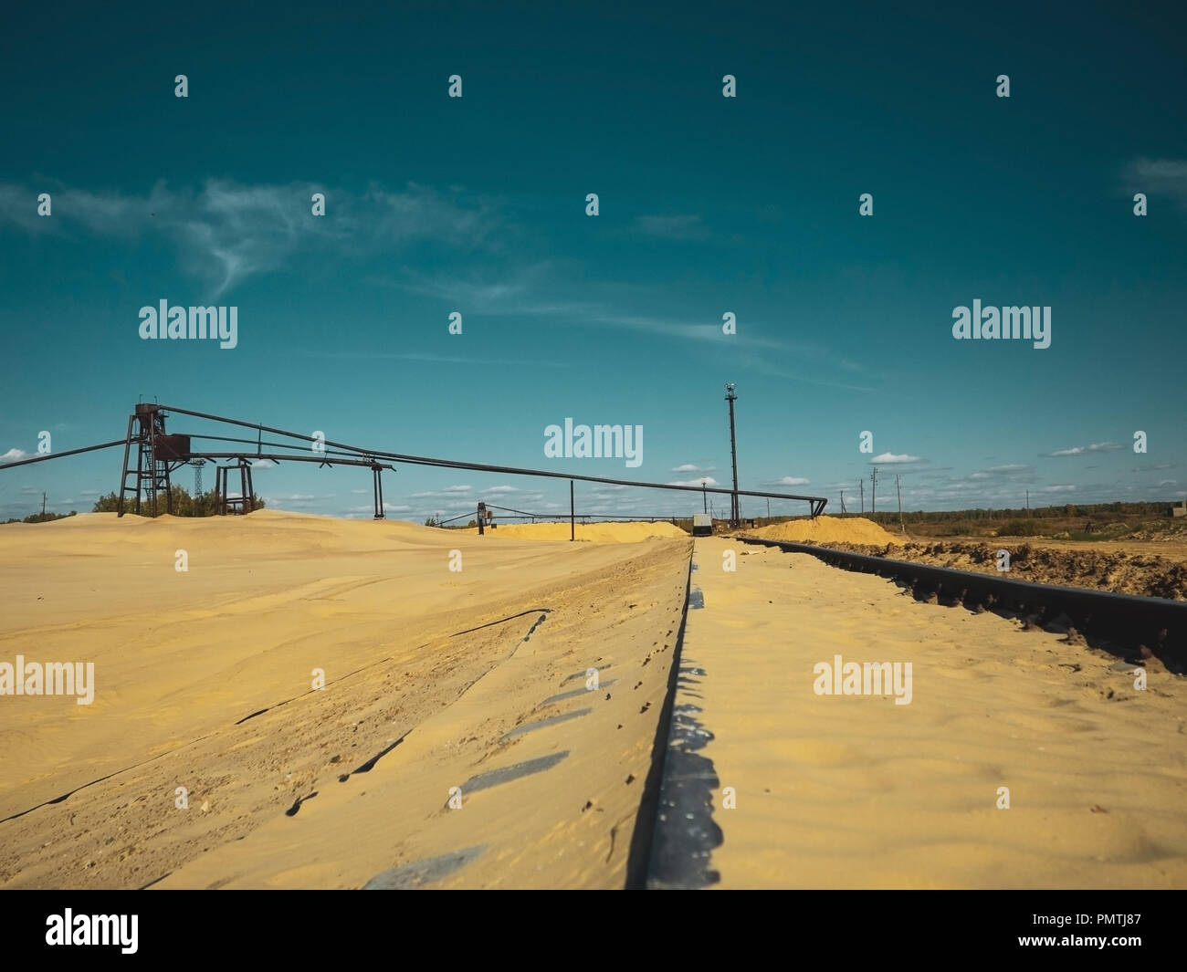 View of the sand pit from the rail level, the contrast of the blue sky ...
