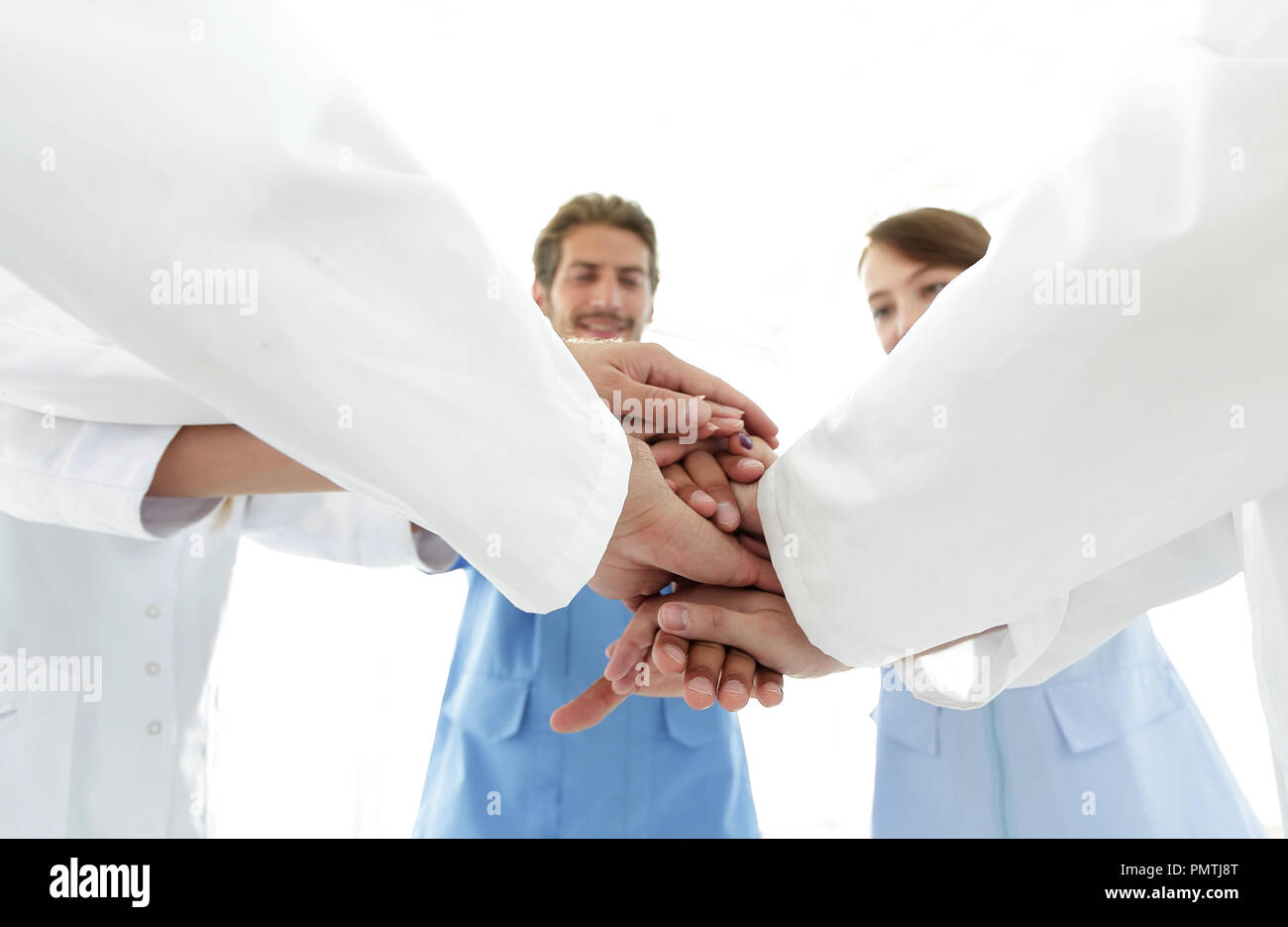 Doctors and nurses in a medical team stacking hands Stock Photo - Alamy