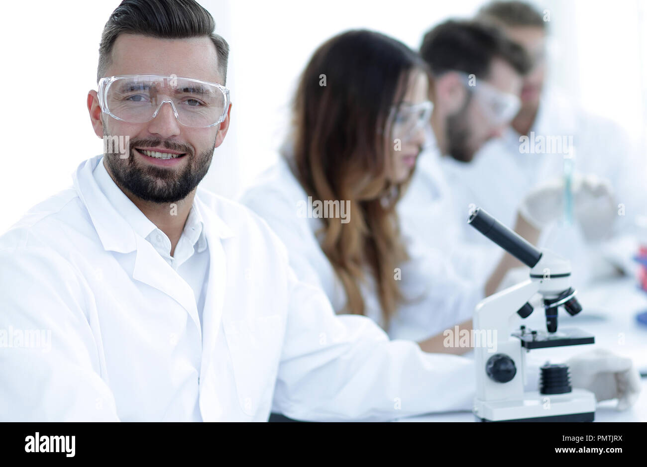 microbiologist and his colleagues are sitting in a modern laboratory ...