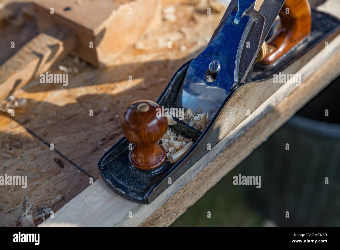 Wood shaving plane on plank. Renovation, construction concept Stock ...