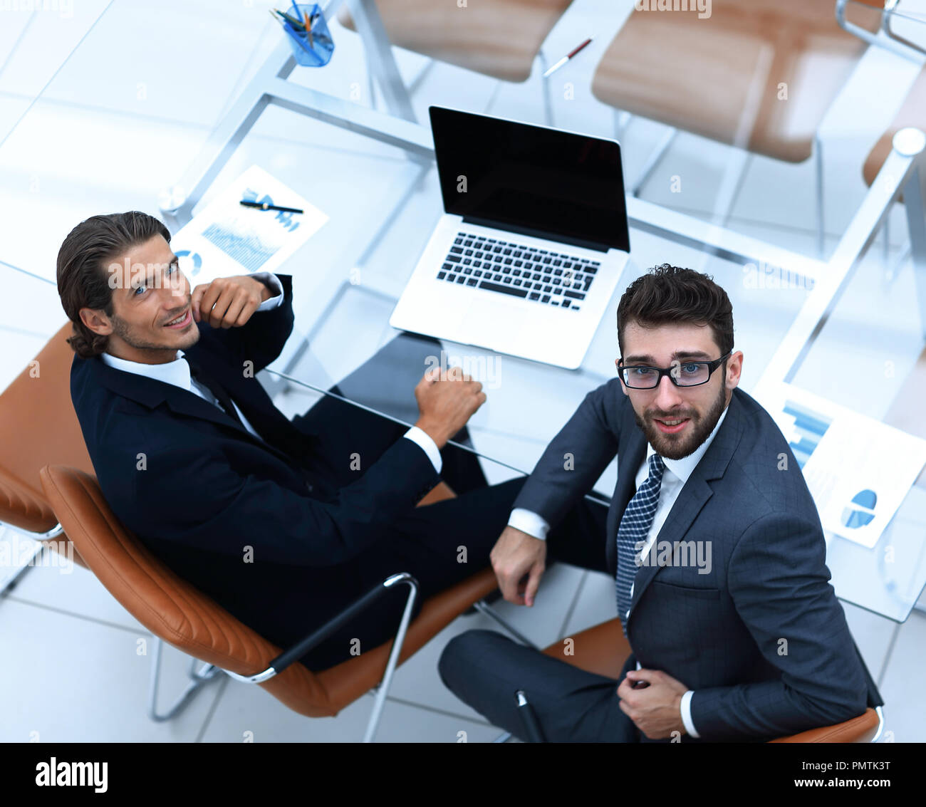 successful employees sitting behind a Desk Stock Photo - Alamy