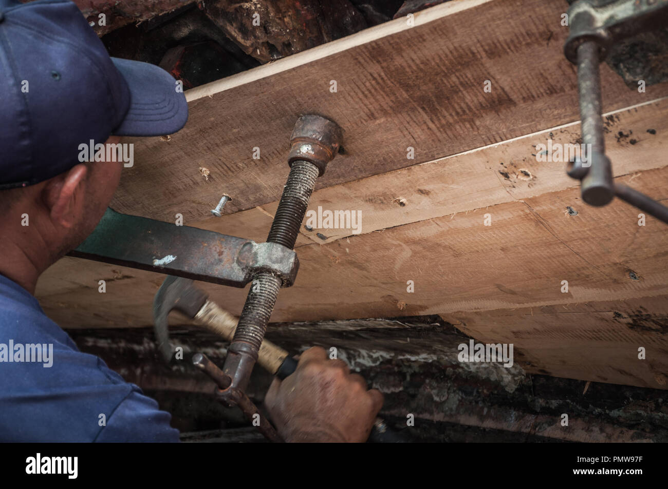 Mechanic maintenance old wood boat on beach with hand, fishery ...