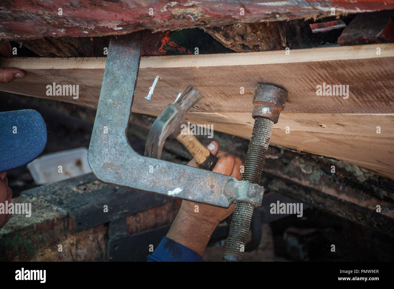 Mechanic maintenance old wood boat on beach with hand, fishery ...