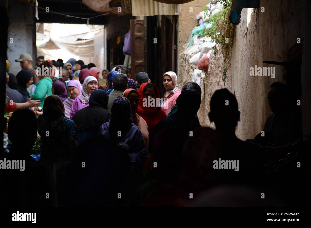 The crowd of muslim women in narrow street of Old Medina of Fez ...