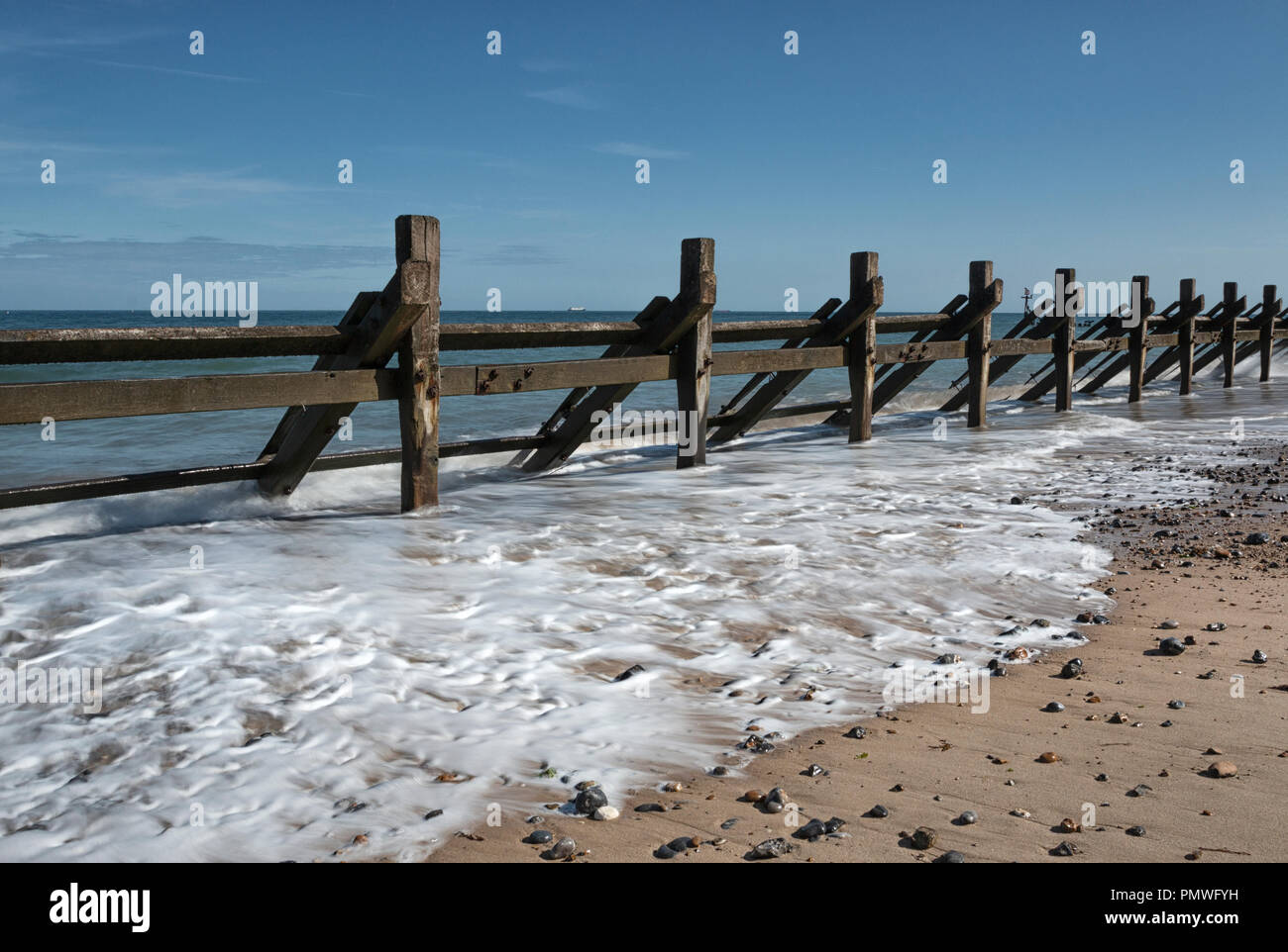 Wooden groynes and revetments on West Runton Beach, North Norfolk, East ...