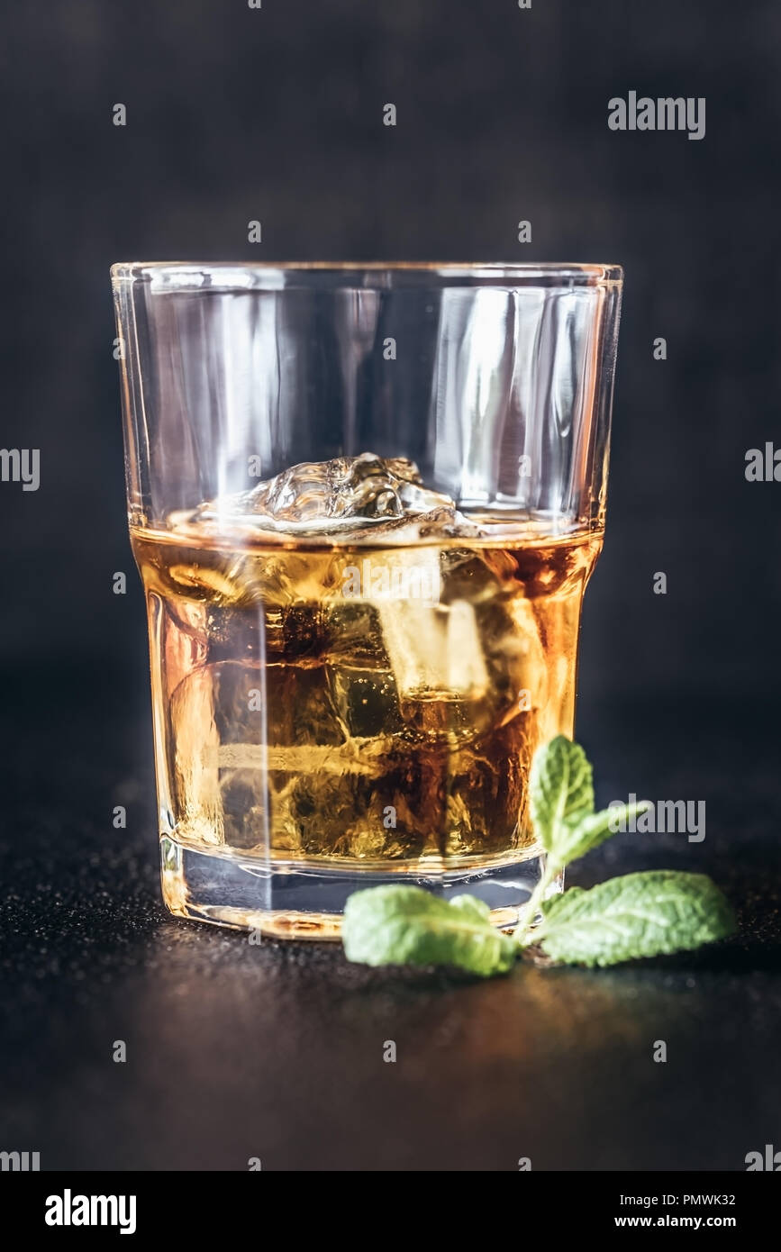 Glass of rum on the dark background Stock Photo - Alamy