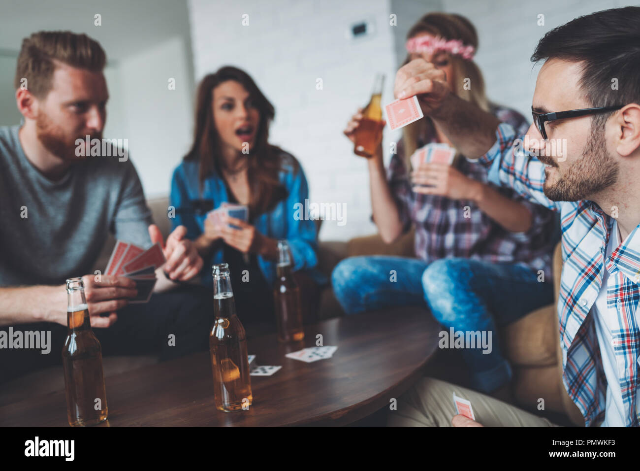Group of friends having fun while playing cards Stock Photo - Alamy