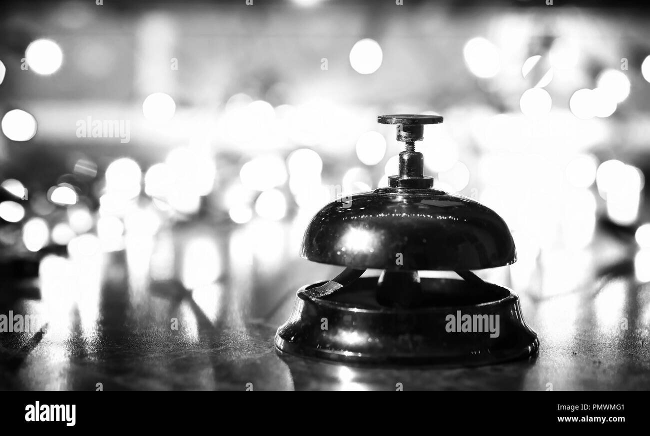 reception bell on the table and shining garland background Stock Photo ...