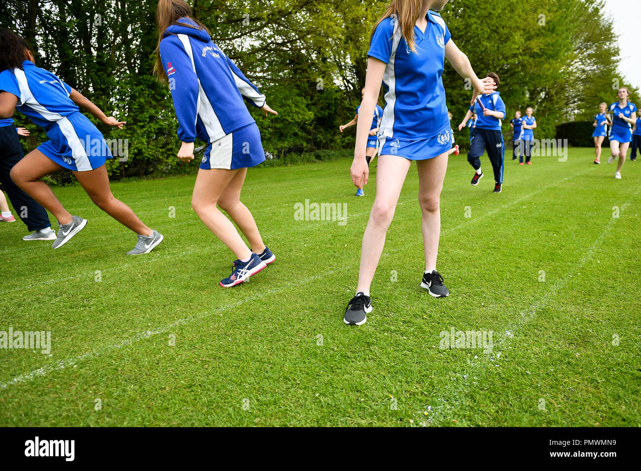 Students practice baton relay during a Physical Education (PE) lesson ...