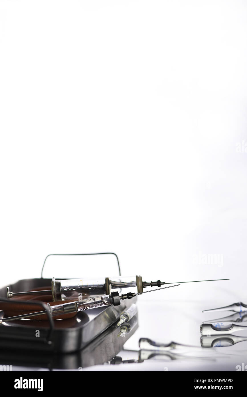 Old metal medical syringe and accessories on the table Stock Photo - Alamy