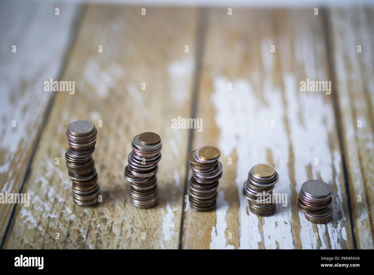 coins stacked in piles on the floor Stock Photo - Alamy