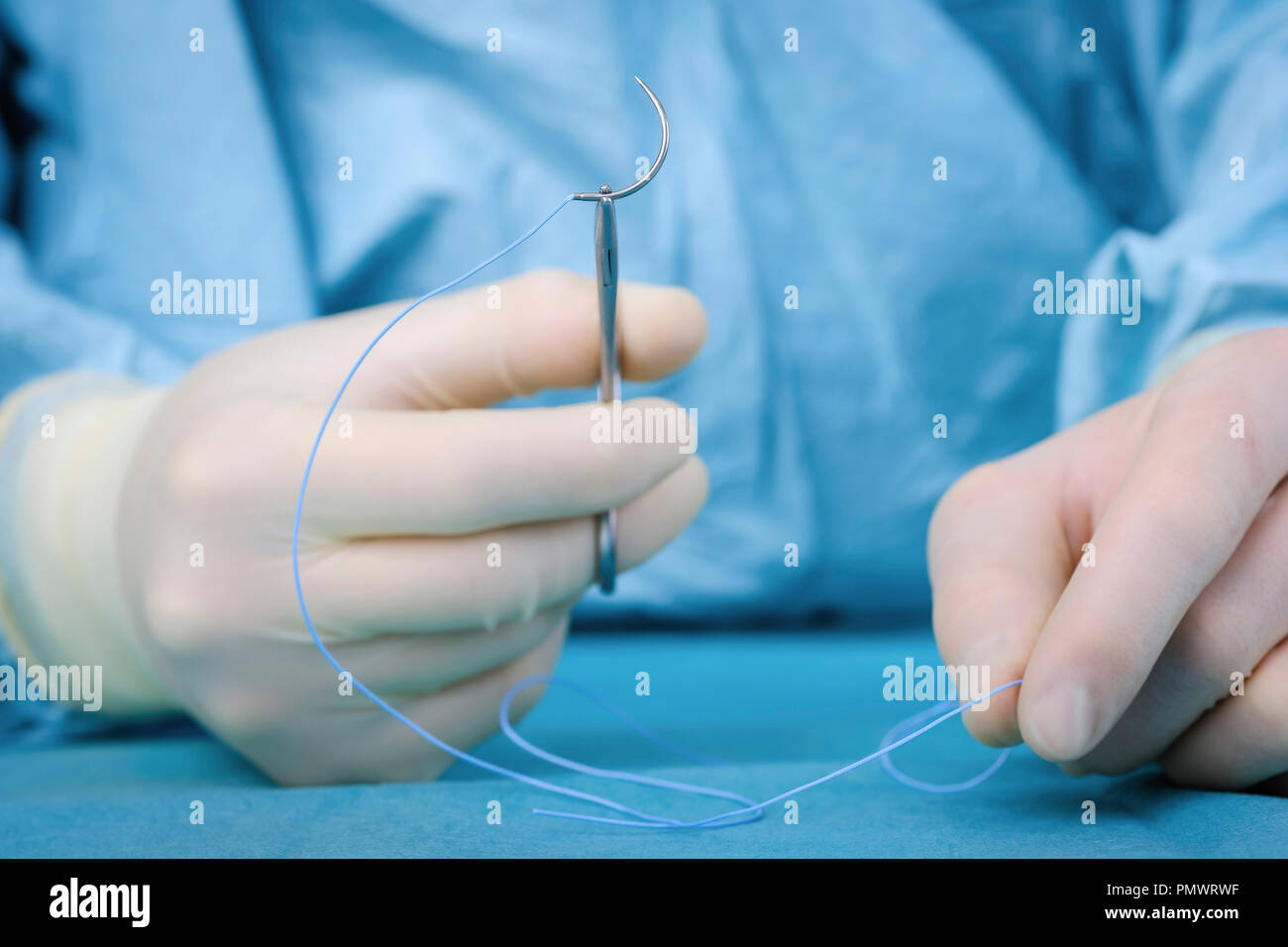 Close up surgeon holding needle Stock Photo - Alamy