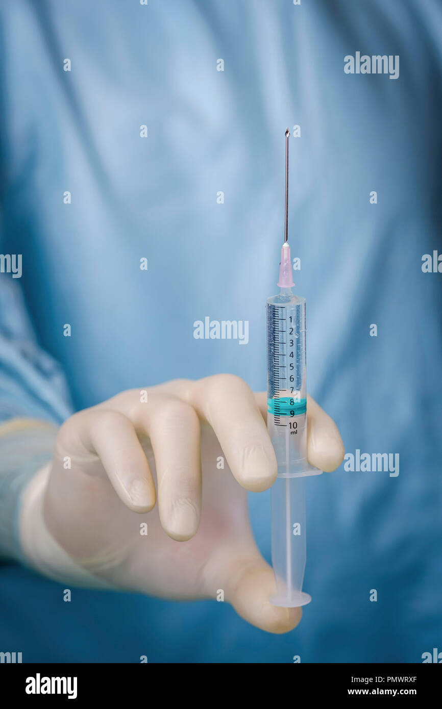 Close up surgeon holding syringe Stock Photo - Alamy