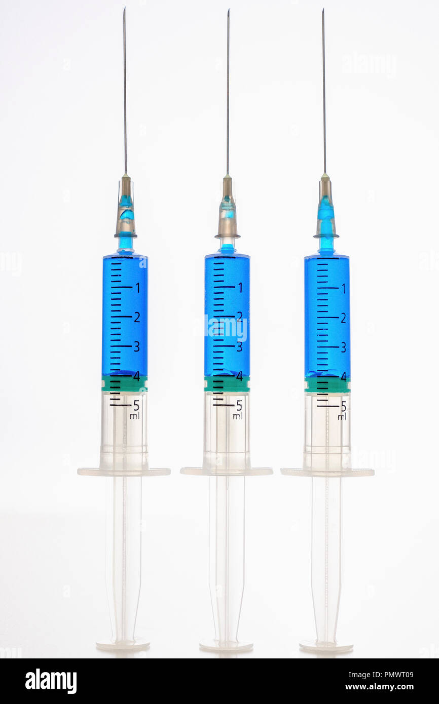 Syringes with blue liquid Stock Photo - Alamy