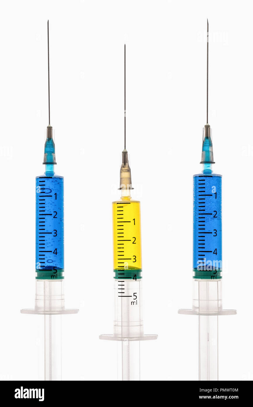 Syringes with blue and yellow liquid Stock Photo - Alamy