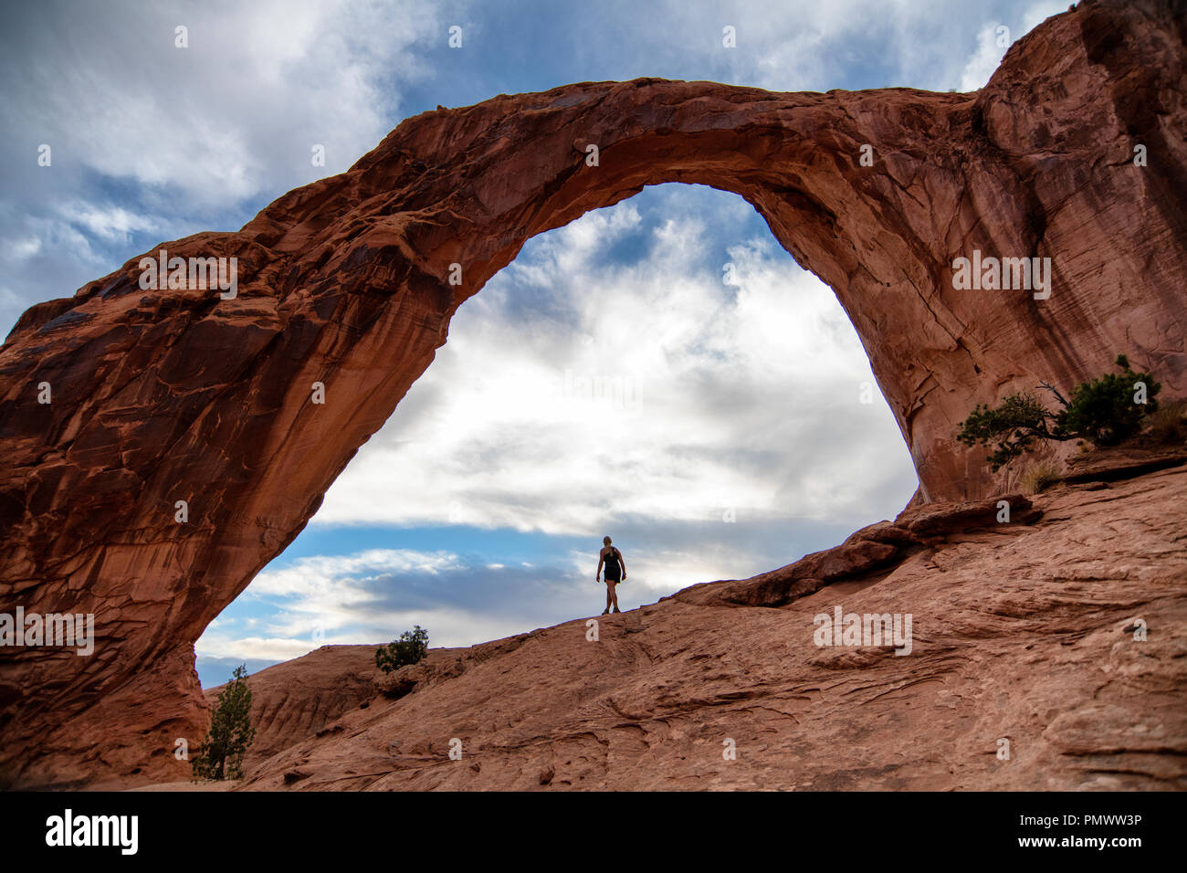 A female hiker beneath Corona Arch, Moab, Utah, USA Stock Photo - Alamy