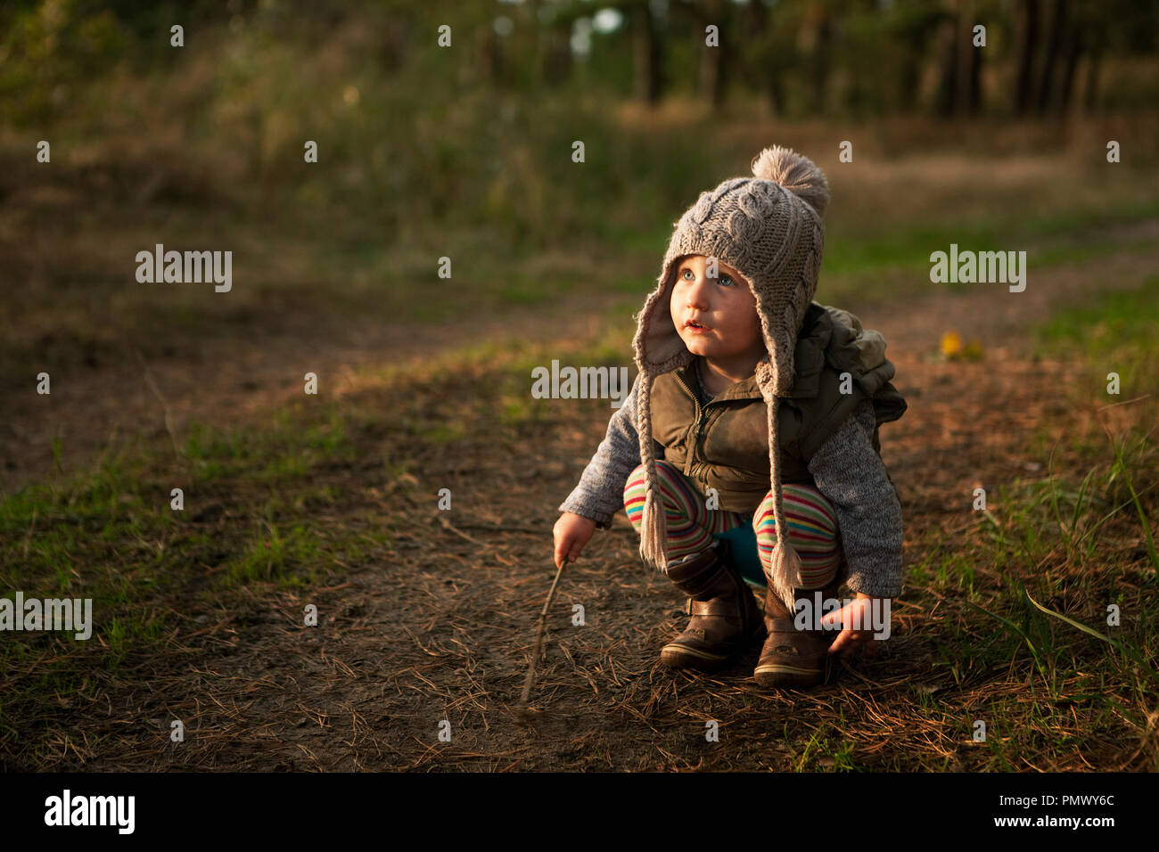 Cute girl playing with sticks Stock Photo - Alamy