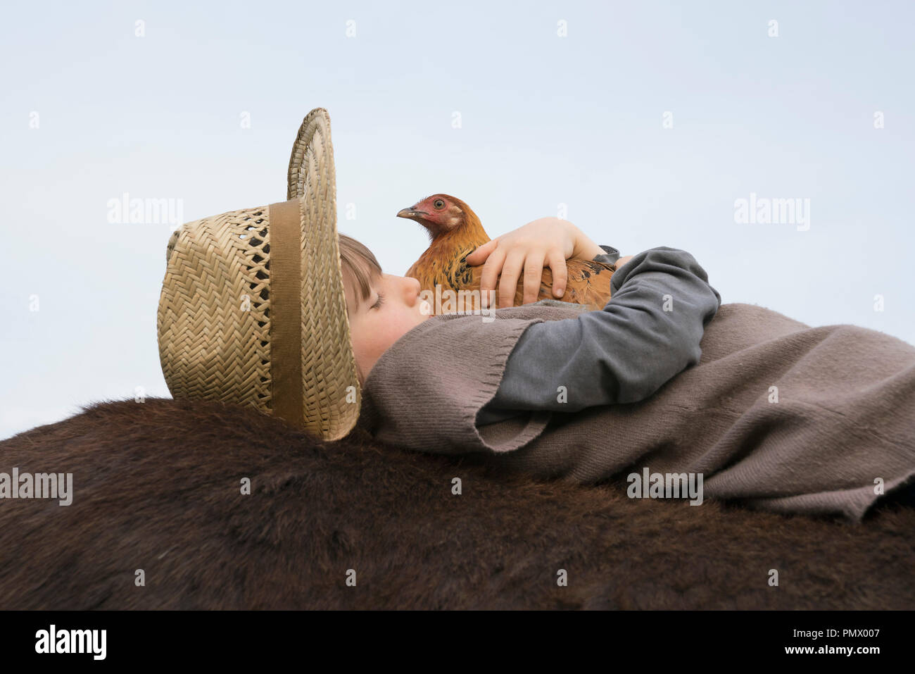 Girl hugging chicken, laying on horse Stock Photo - Alamy