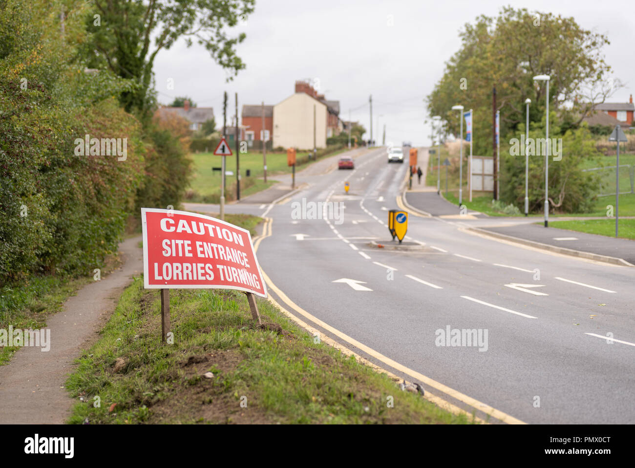 Caution site entrance lorries turning warning road sign on British road ...