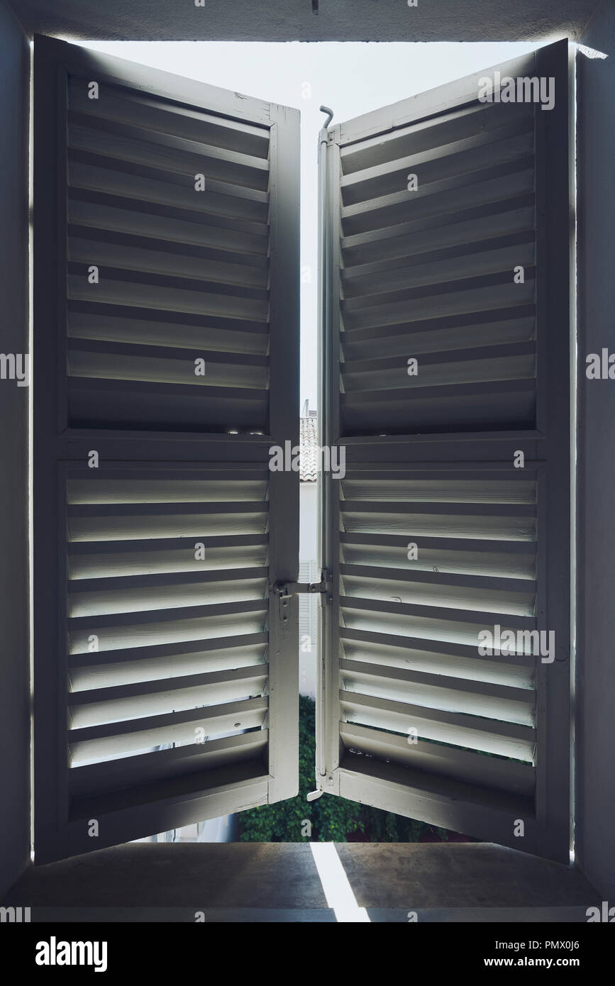 Sunlight behind white wood shutters Stock Photo - Alamy