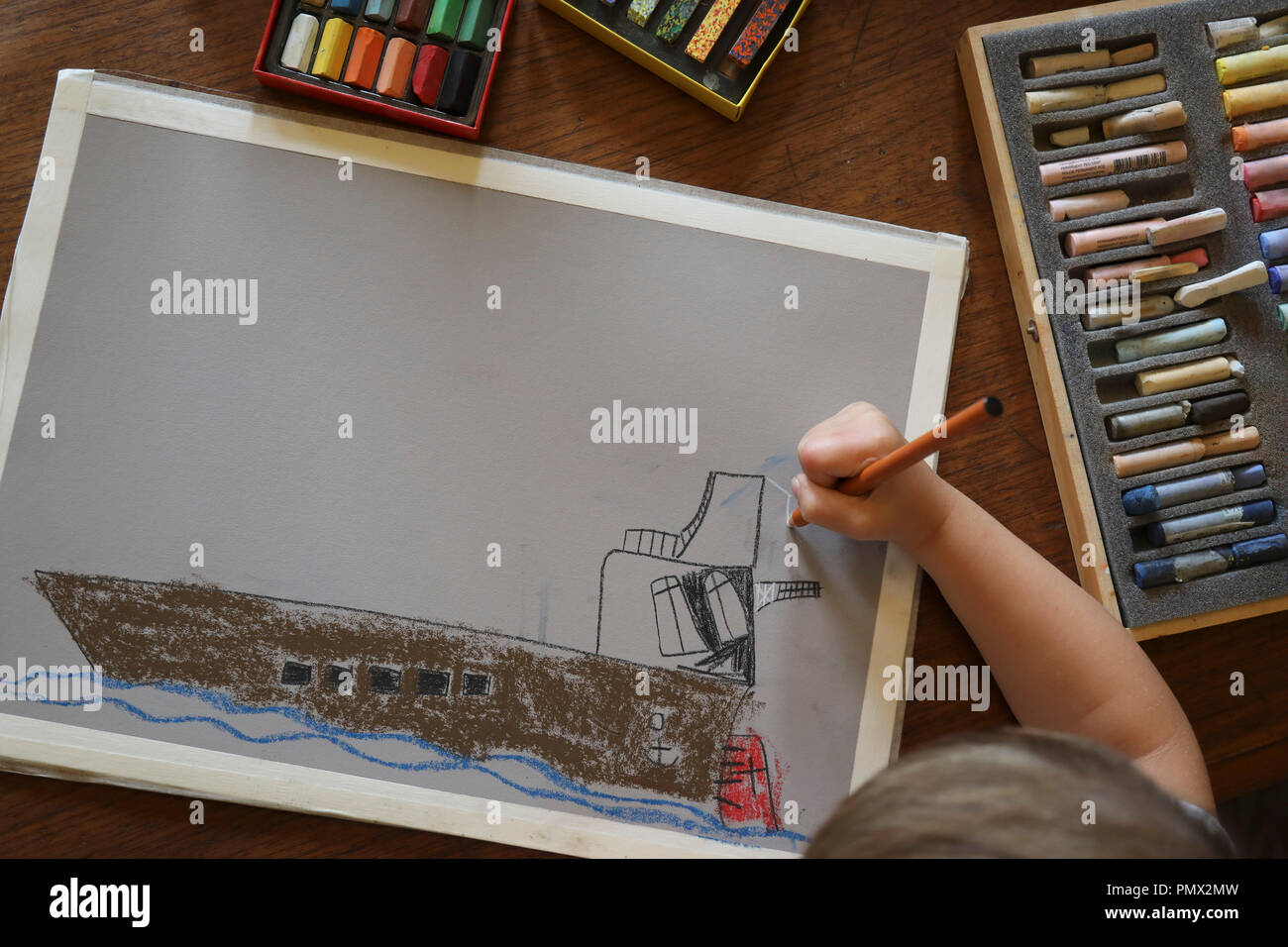 View from above boy drawing boat Stock Photo - Alamy