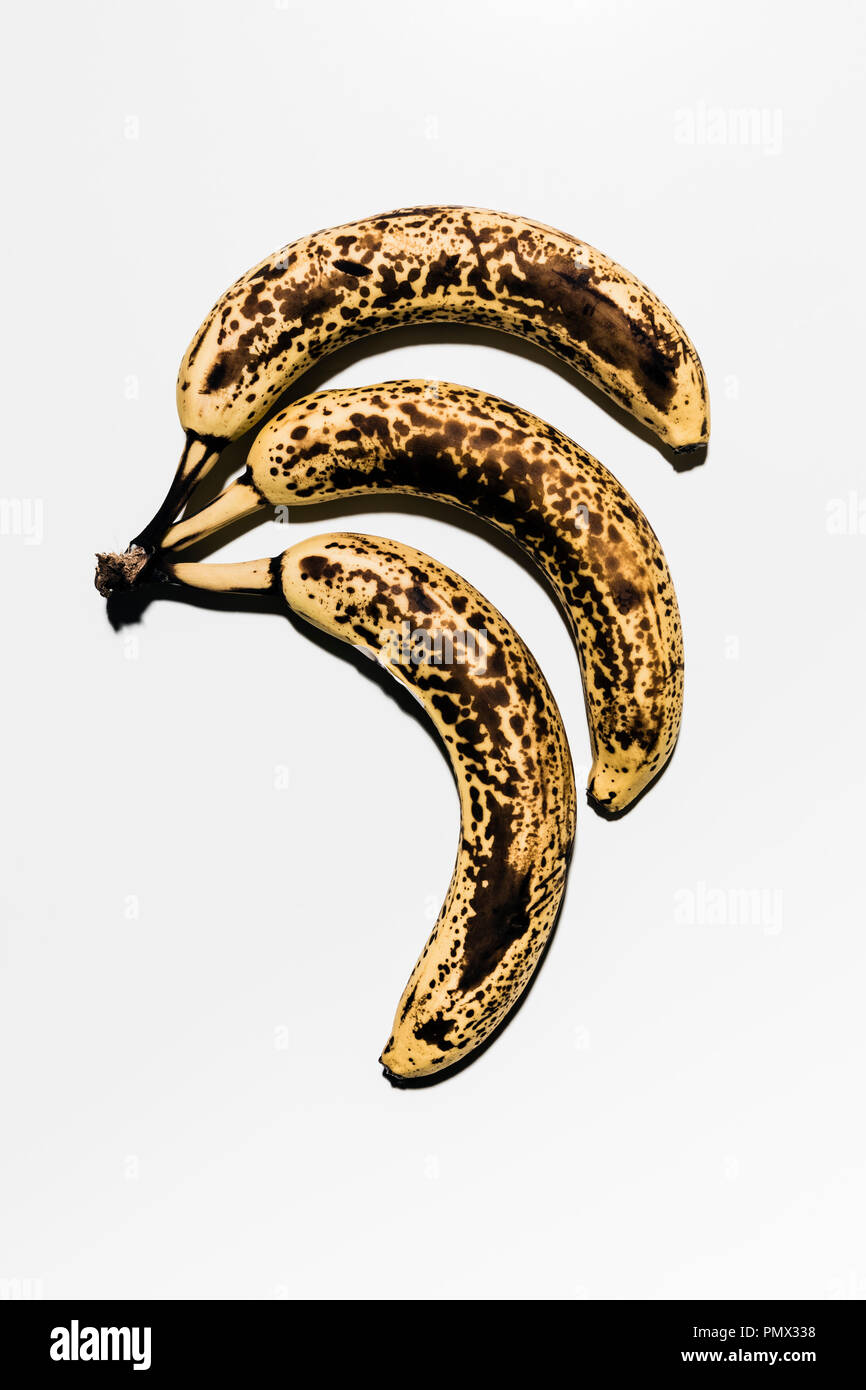 Rotting, ripe bananas against white background Stock Photo - Alamy