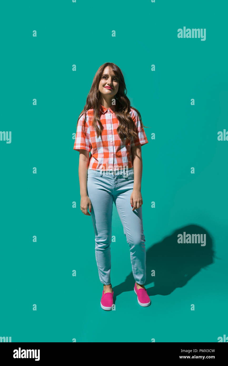 Portrait confident young woman against turquoise background Stock Photo ...