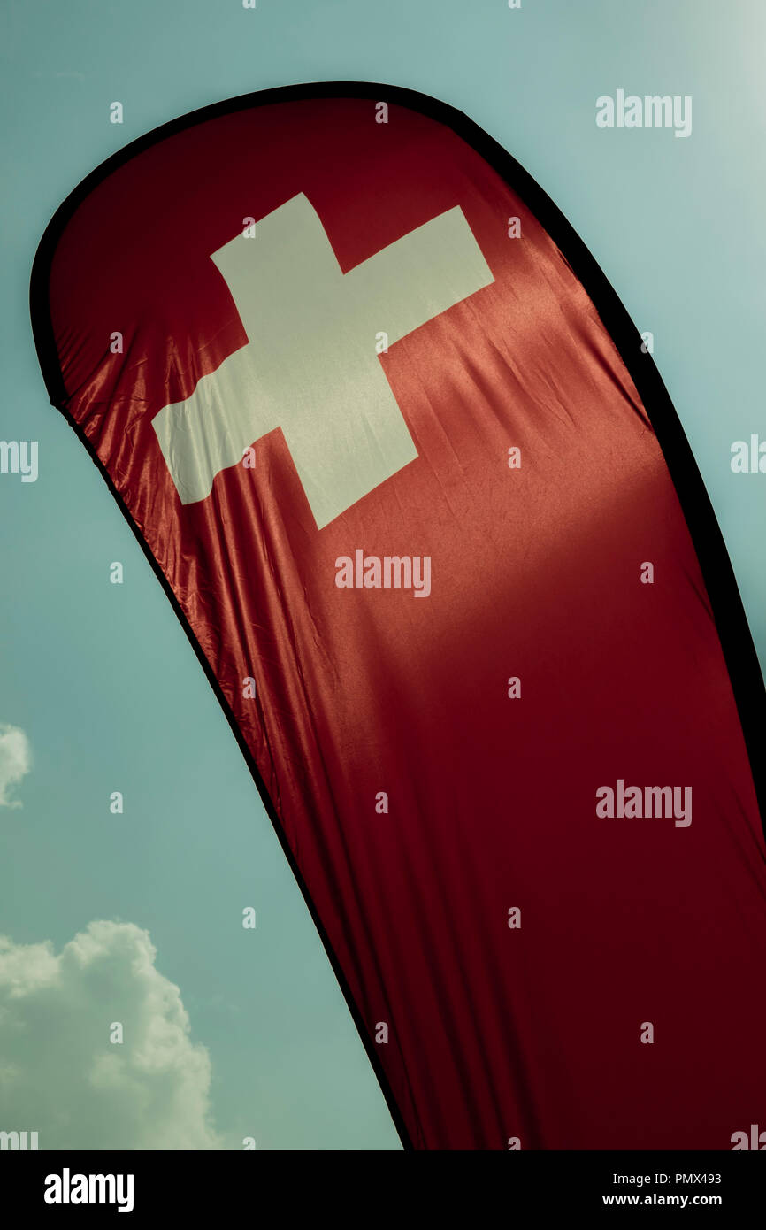 Swiss Banner Flag with Sunlight and Against Sky with Cloud Stock Photo ...