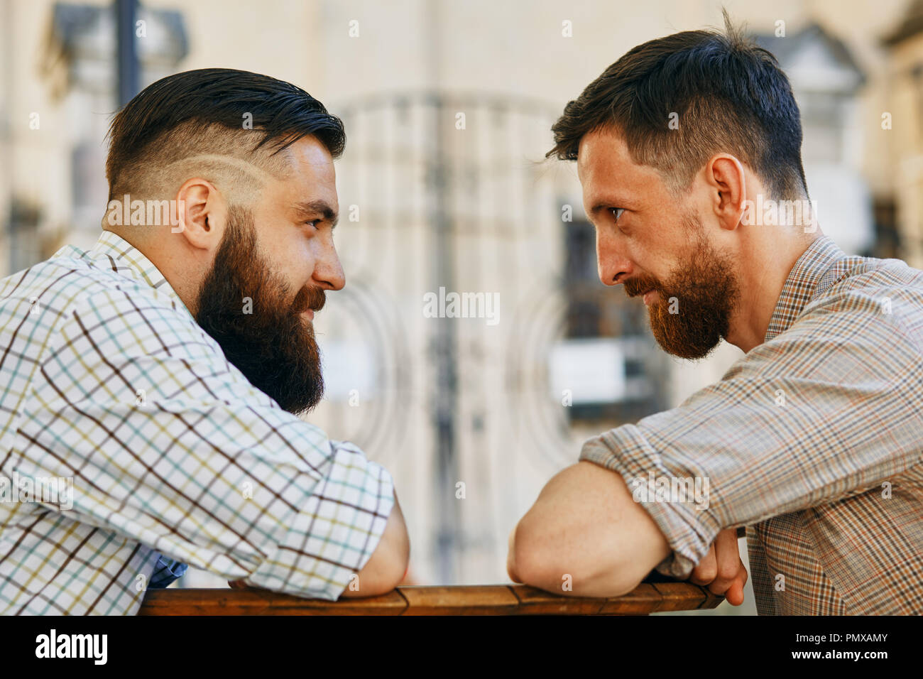 two men communicate with their views at the table Stock Photo - Alamy