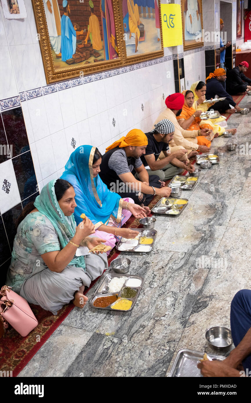 Women & men eating in a Sikh temple langar where a free vegetarian meal ...