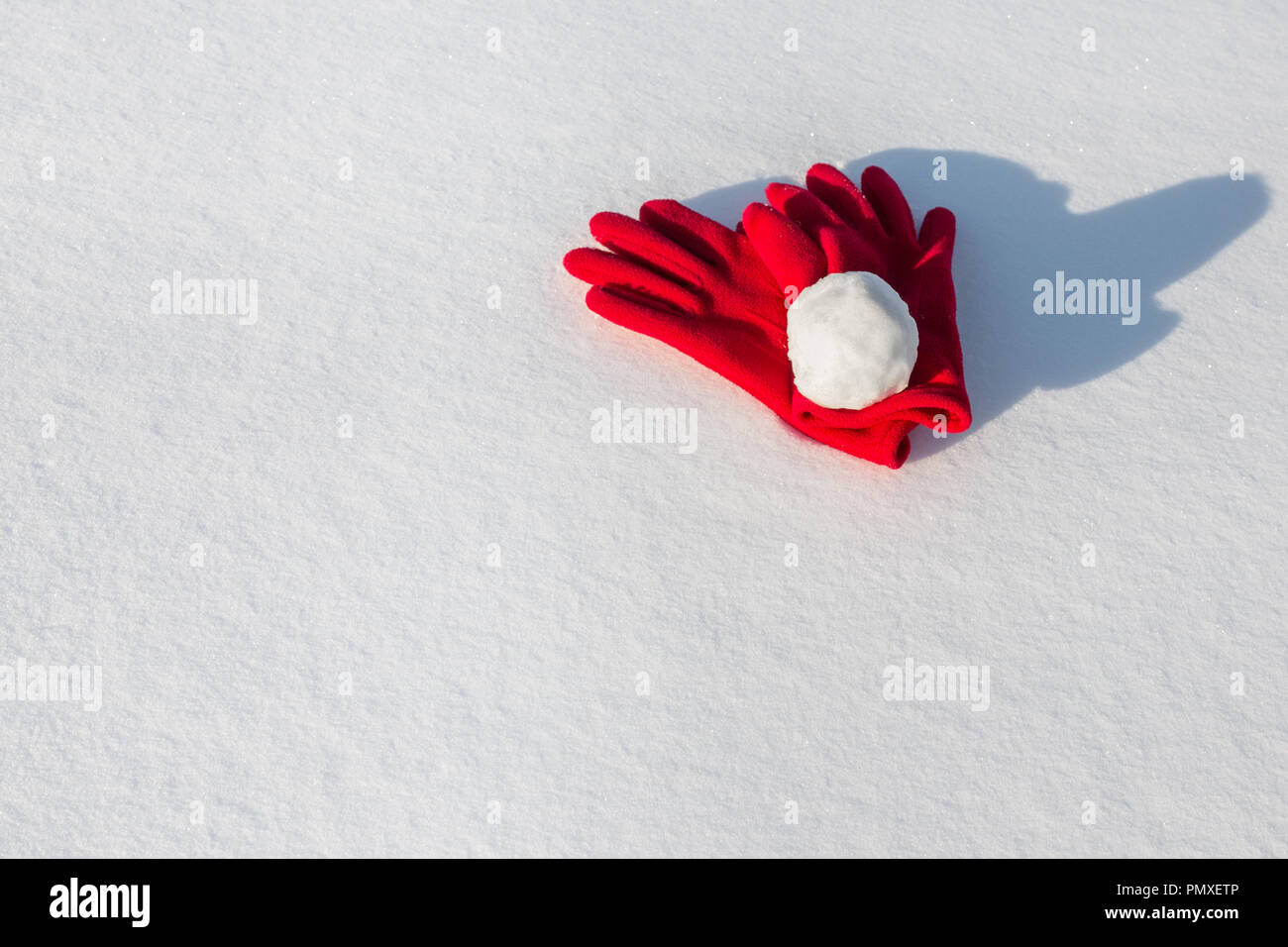 snowball on red gloves on snow background. Concept of winter season ...