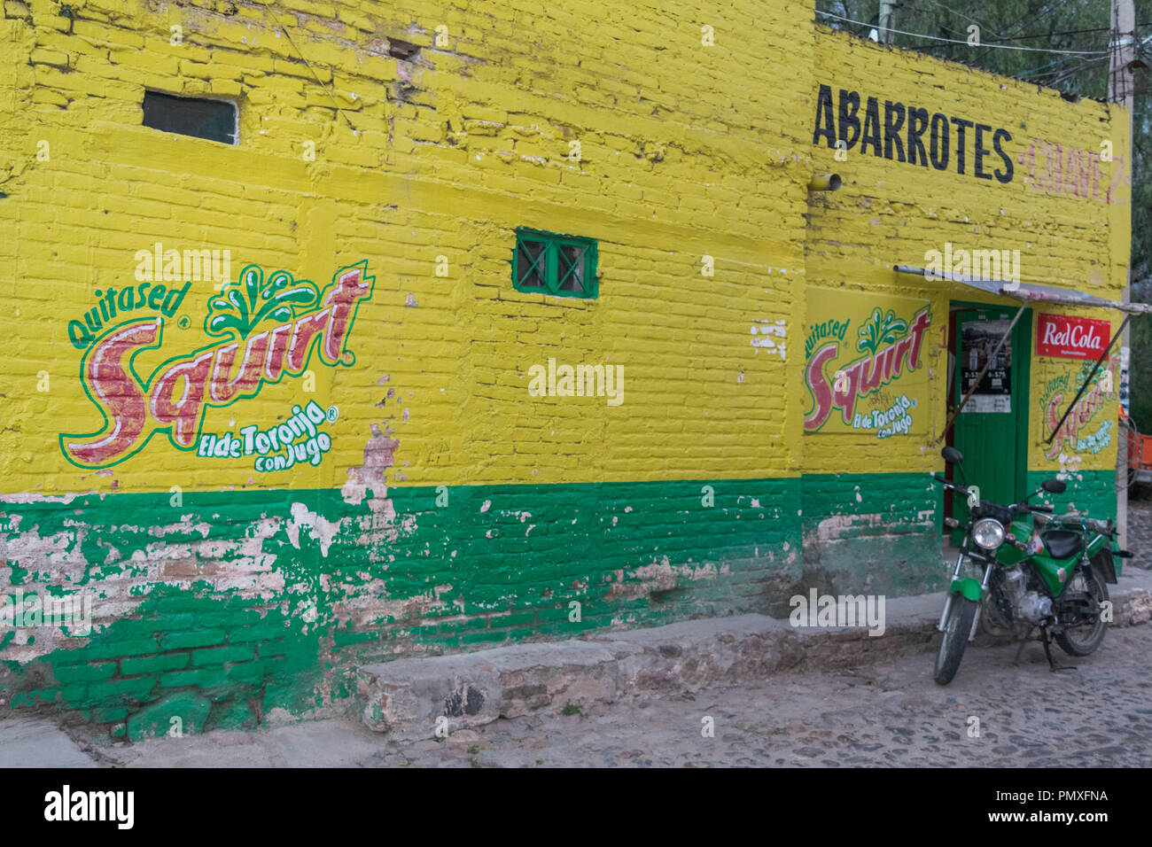Colorful yellow and green painted shop front hi-res stock photography ...