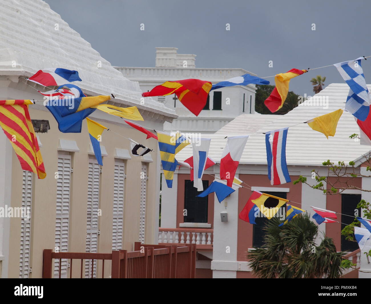 Multi colored flags over cityscape of St. Georges Bermuda Stock Photo ...