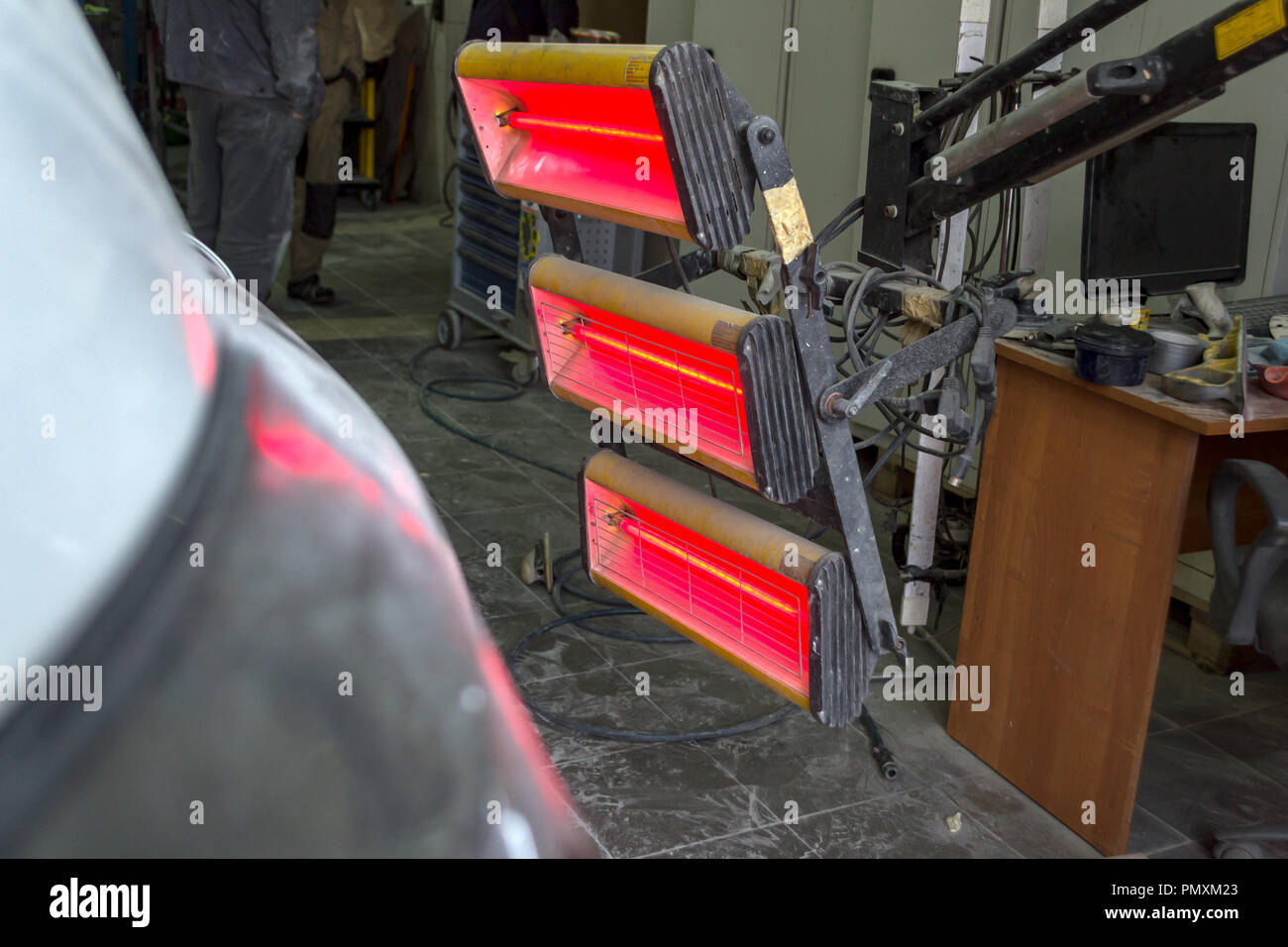 Infrared drying of car body parts after applying putty and paint on a ...