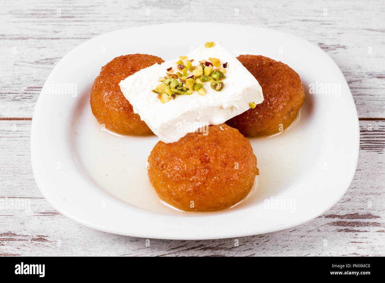 Turkish traditional dessert Kemalpasha, Shekerpare with cream on top ...