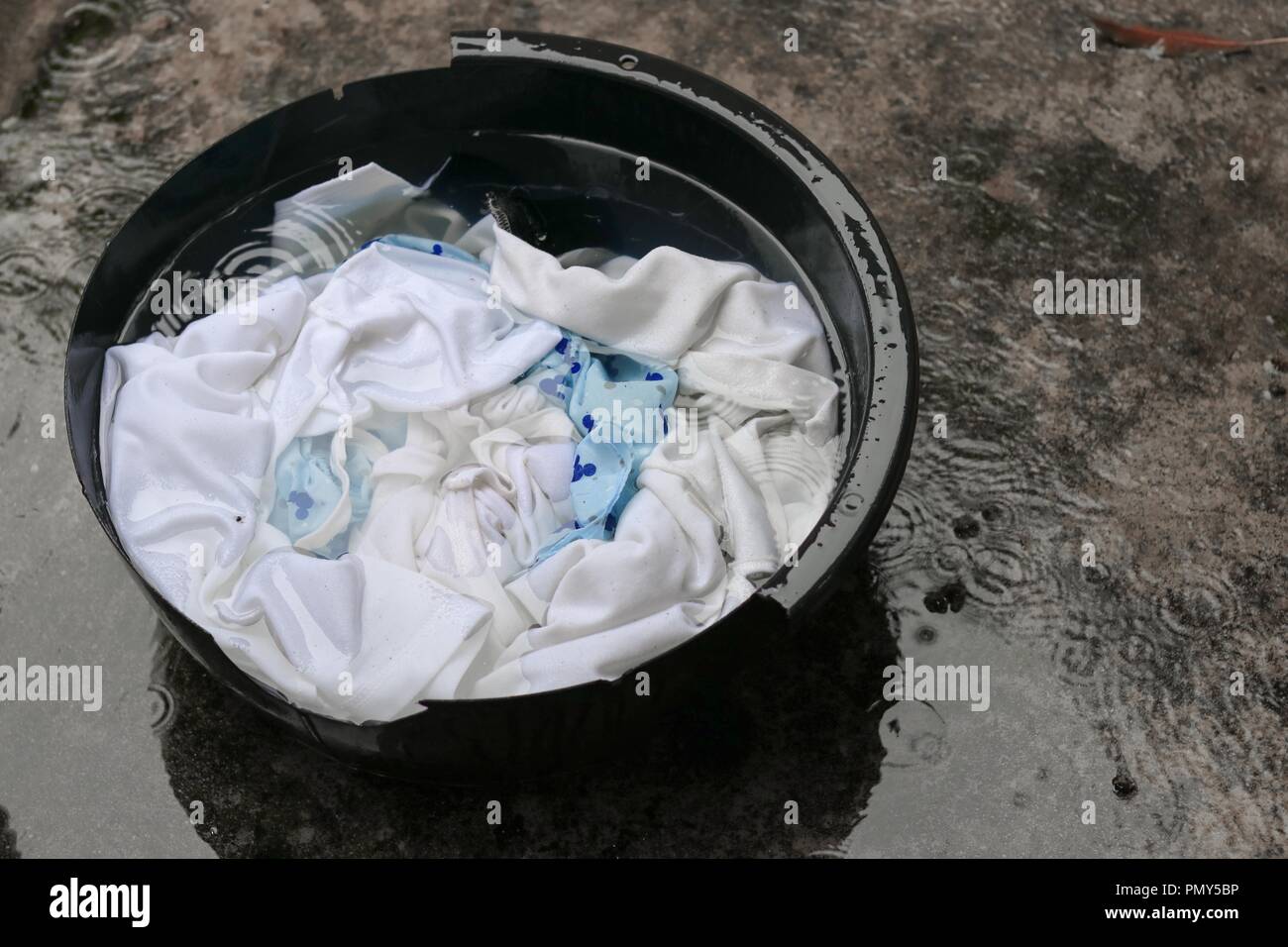 soak dirty clothes in the basin black old Stock Photo - Alamy