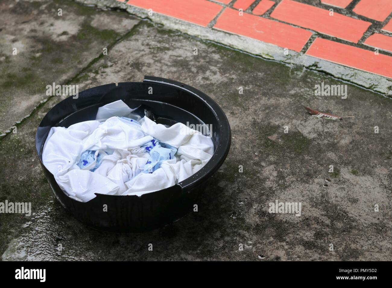 soak dirty clothes in the basin black old Stock Photo - Alamy