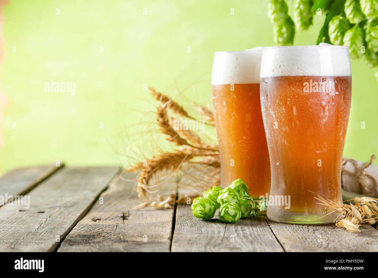 Beer and ingredients hops, wheat, barley on wood background Stock Photo ...