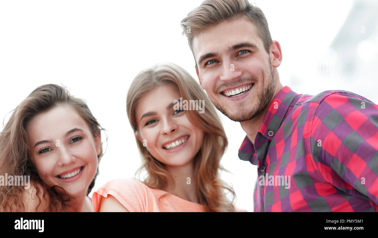 closeup of three young people smiling on white background Stock Photo ...
