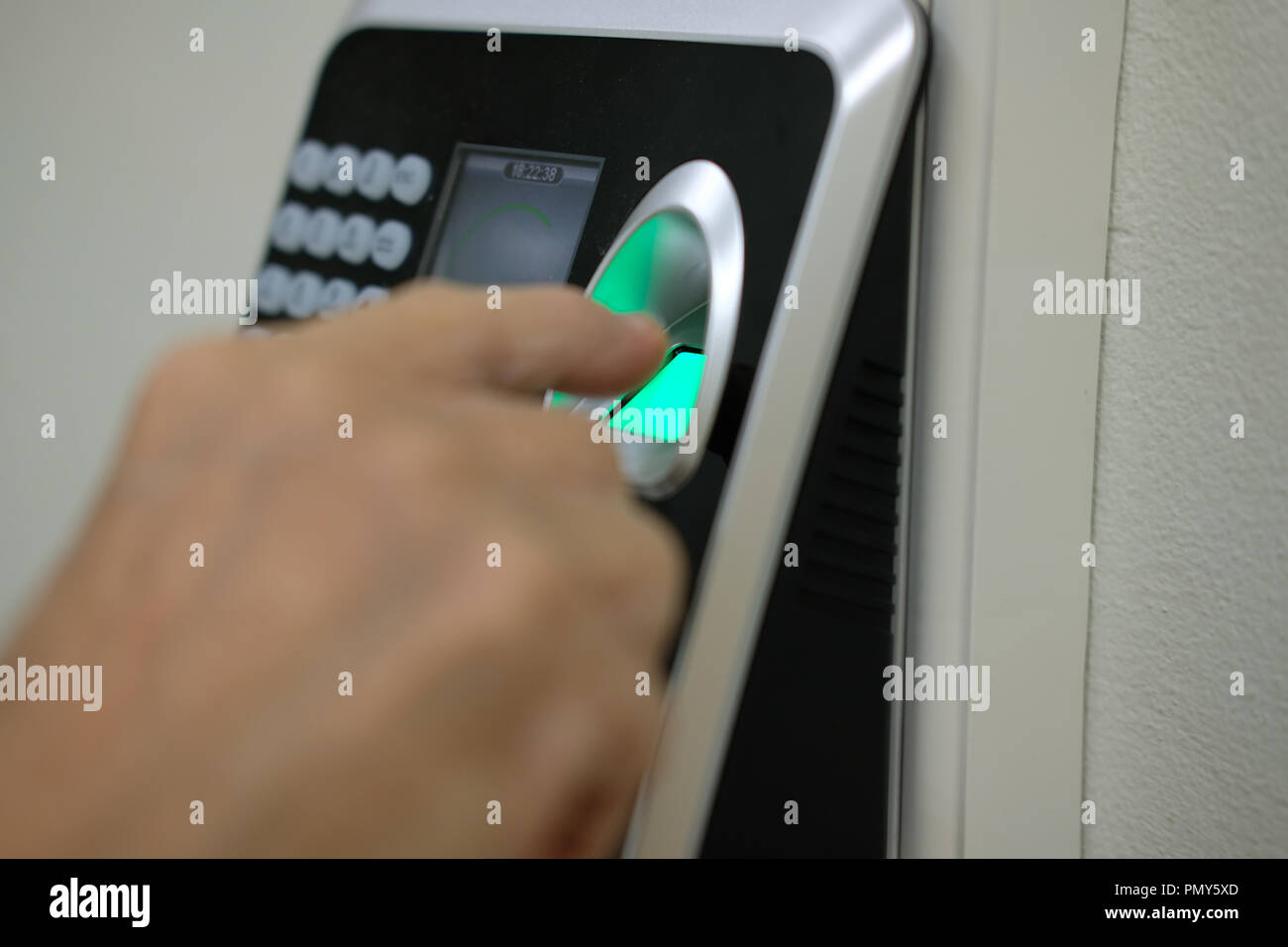 hand scanning finger print on access control machine. hour work time ...