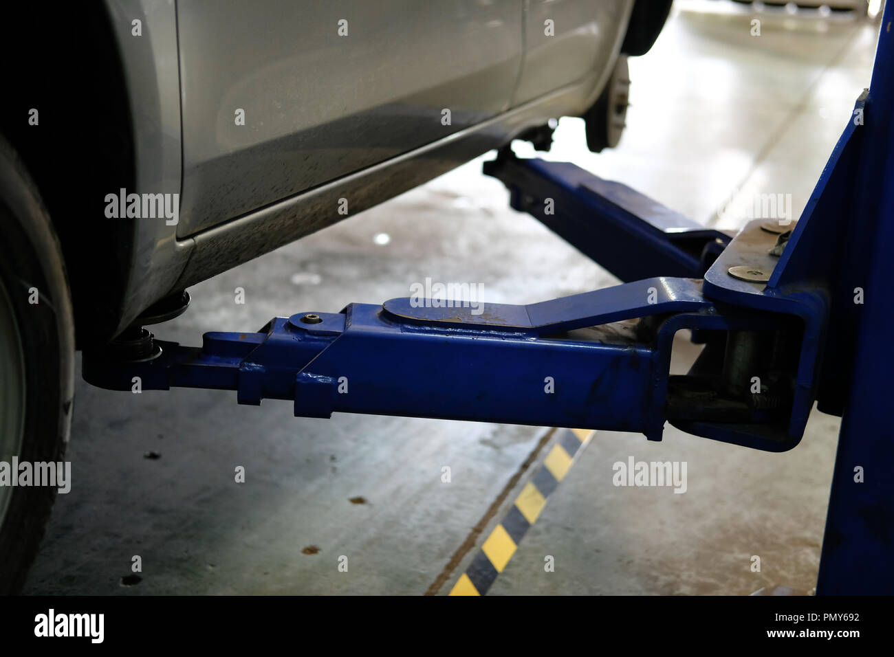 car on lift in automobile service repair garage Stock Photo - Alamy