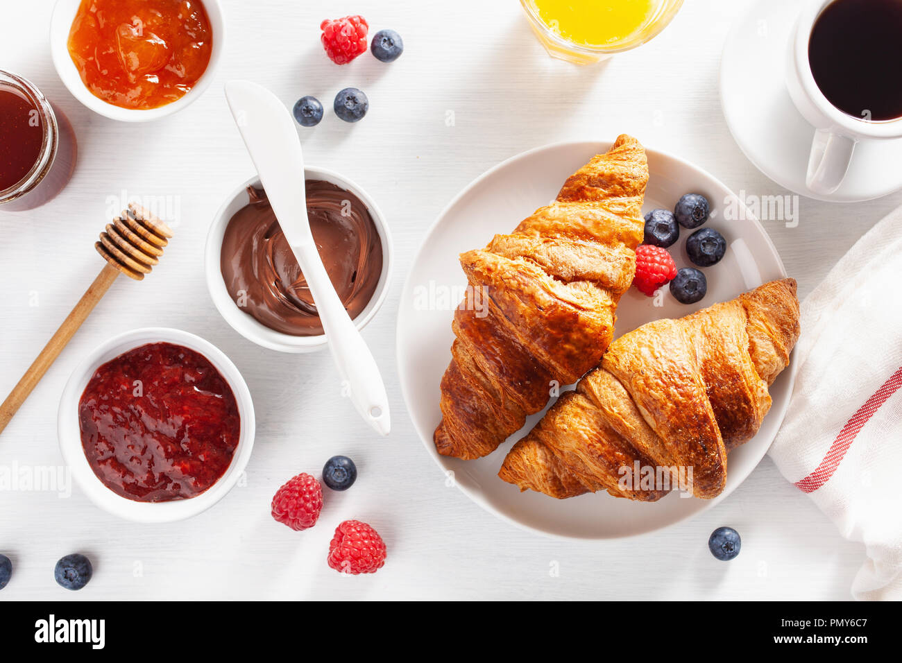 Continental breakfast with croissant, jam, chocolate spread and coffee ...