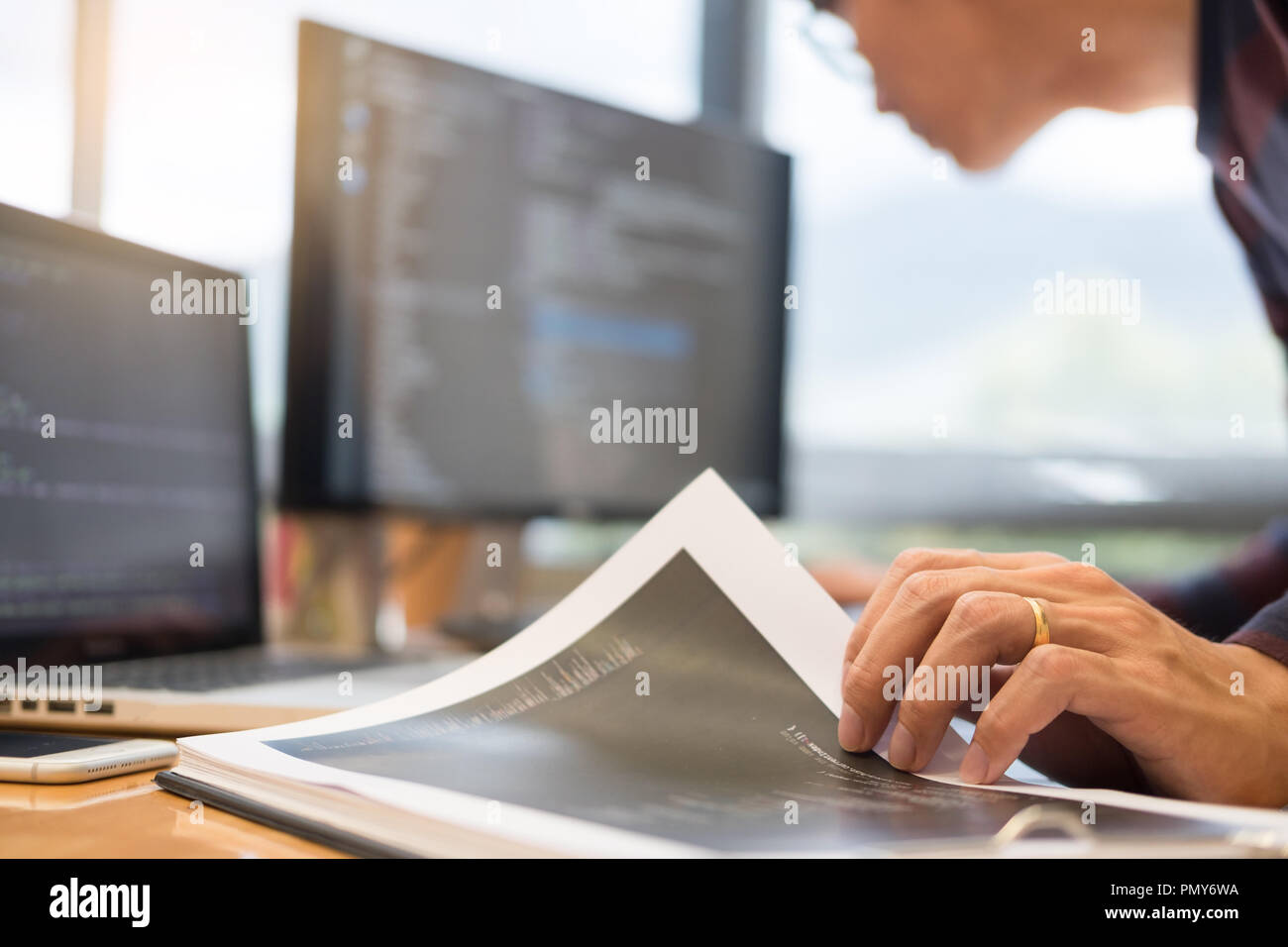 Pensive programmer working on on desktop pc programming code technologies or website design at ...