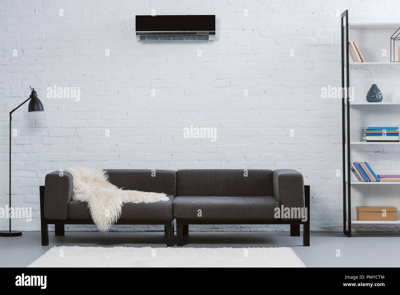 modern air conditioner hanging on white brick wall at living room Stock ...