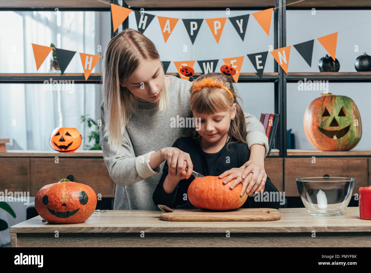 Child helping siblings in the home hi-res stock photography and images ...