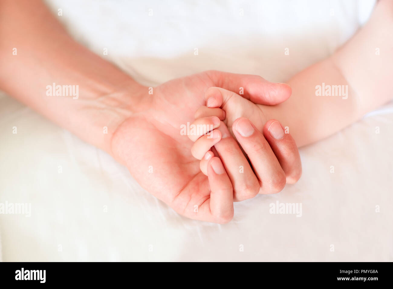 Father holding the hand of his new born son, shallow DOF. Trust ...