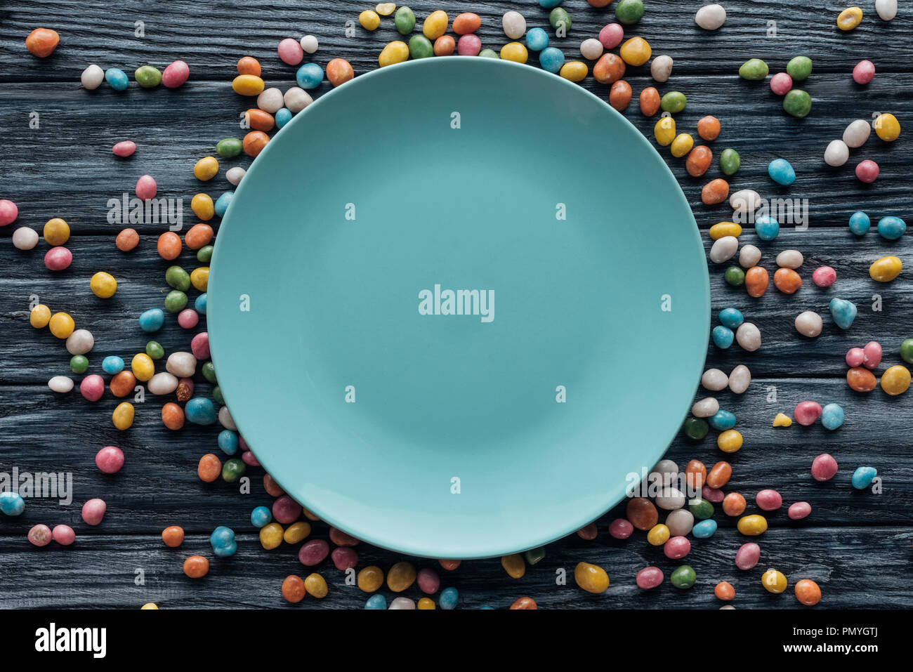 Colorful candies on wooden plate hi-res stock photography and images ...