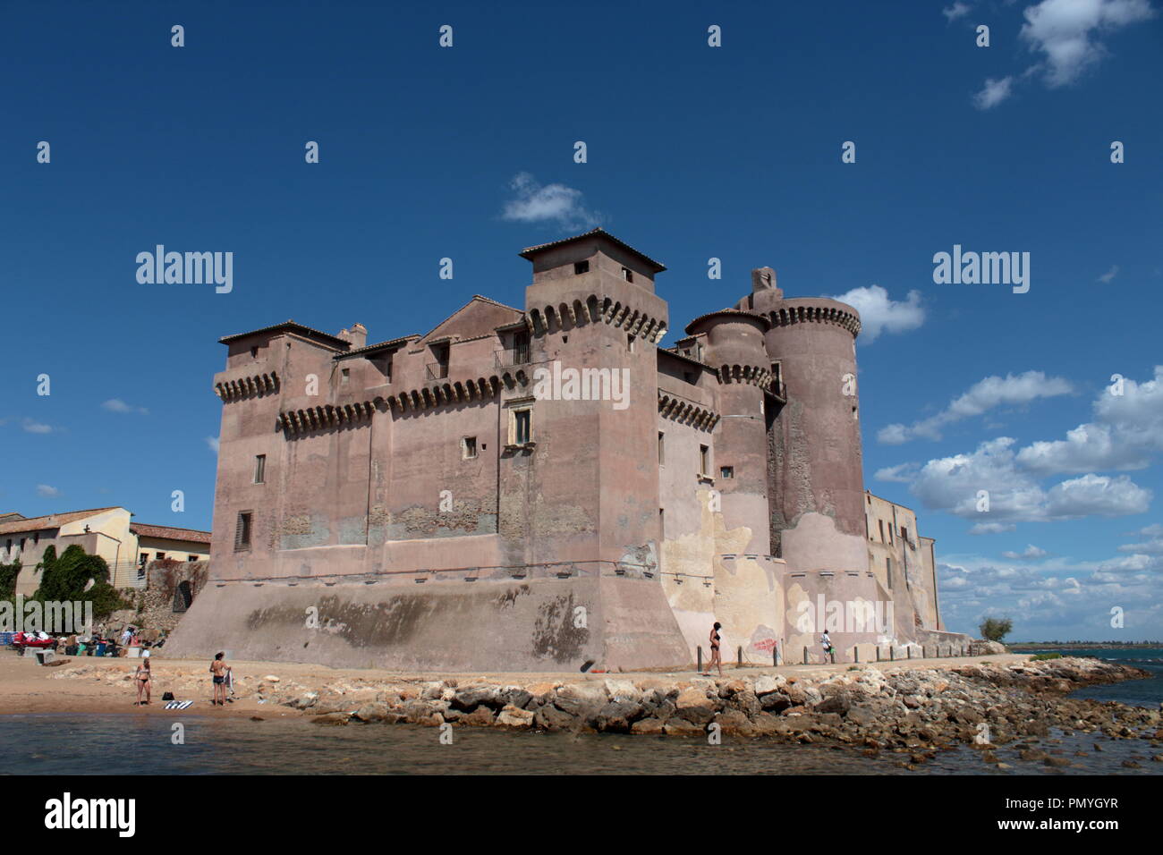 medieval castle of Santa Severa perched on the sea with tourists Stock ...