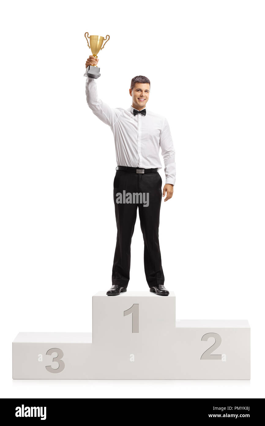 Full length portrait of a young man with a golden trophy standing on a ...